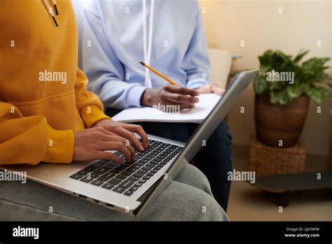 Hands Of Female College Student Coding On Laptop When Her Friend Hands Of Female College Student Coding On Laptop When Her Friend