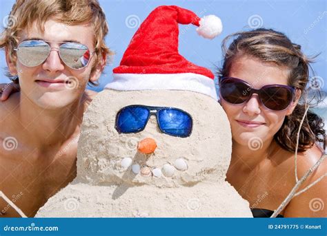 Portrait Of Couple And Sand Snowman On Beach Stock Image Image Of
