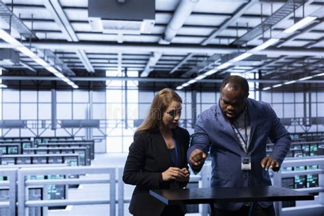 coworkers using augmented reality in server room to reduce downtime