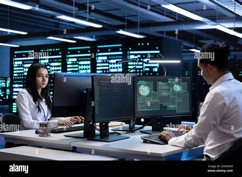 programmers using computer in server room to support global connections