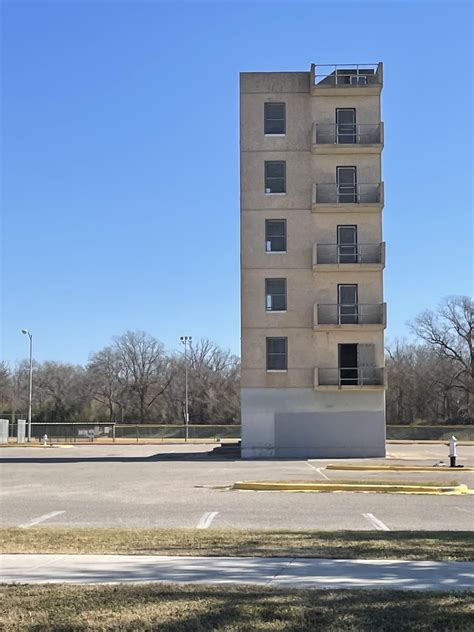 What Is This 6 Floor Tiny Tower In The Middle Of A Parking Lot Adjacent A Baseball Field In