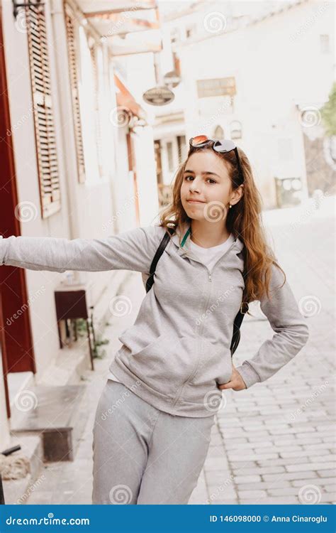 Young Beautiful Girl Walks Along The Stone Street Of The Old City Of