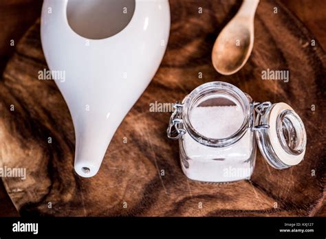 Neti Pot Ayurvedic Tools For Cleaning Nose With Water And Salt View From Top Wooden Table And