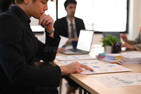 Side View Of Concentrated Businessman Analyzing Financial Data While
