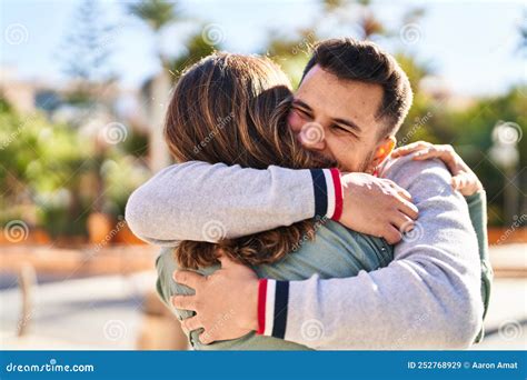 Man And Woman Smiling Confident Hugging Each Other Standing At Park