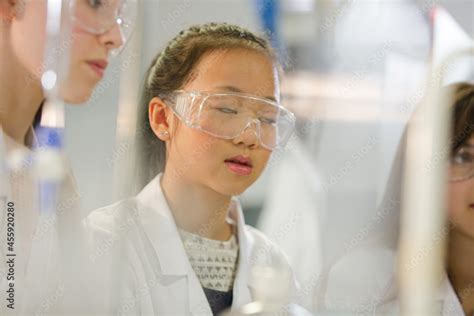 Girl Babe Examining Pink Liquid Conducting Scientific Experiment In Laboratory Classroom