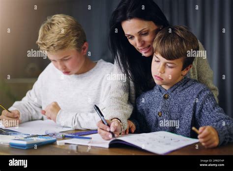 Parents Make The Best Teachers A Mother Helping Her Sons With Their Homework Stock Photo Alamy
