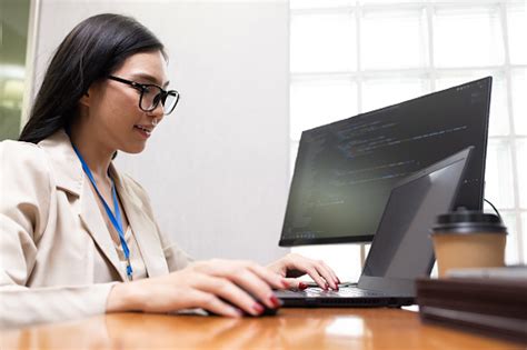 Asian Programmer Woman Working On Computer And Typing Source Code For