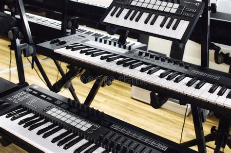 A Collection Of Several Digital MIDI Keyboards With Knobs And Faders