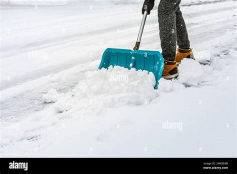 Cleaning Snow From Street In Winter With Shovel After Snowstorm Cleaning Sidewalk From Snow On
