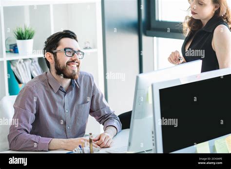 Web Programmer Wearing Glasses And Shirt Is Sitting At The Desk In Happy Mood Job Well Done