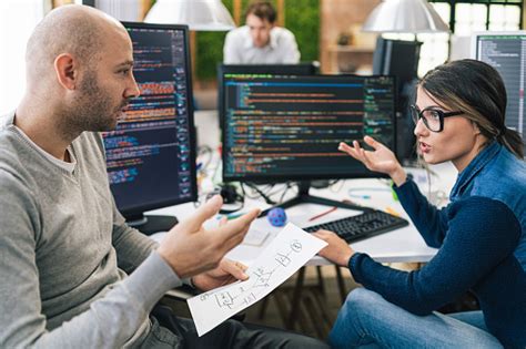 Software Programmers Analyzing Html Code And Database Brainstorming Script Ideas To Develop New