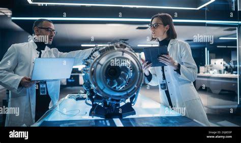 Professional Multicultural Team Of Female And Male Engineers Working On Industrial Jet Turbine