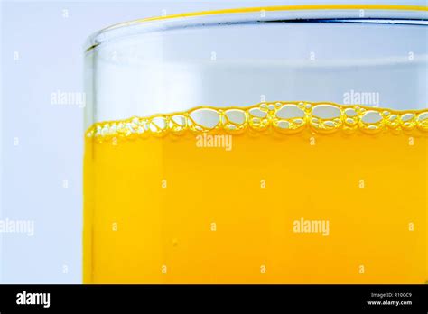 Bubbles Of Orange Soda In A Glass Closeup Macro Textured Background