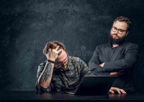 two programmers are thinking hard trying to find a solution to the problem in office against a