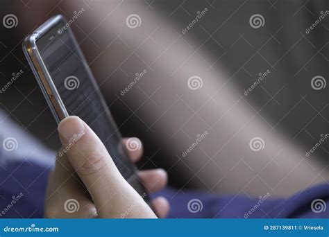 Man Scrolling And Reading Messages On His Smartphone Stock Image Image Of Organ Clothing