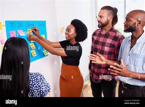 Scrum Team Participates In Daily Stand Up On KANBAN Board Mobile App Developers Stock Photo Alamy