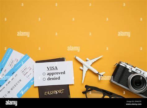 Flat Lay Composition With Passport Toy Plane And Camera On Orange
