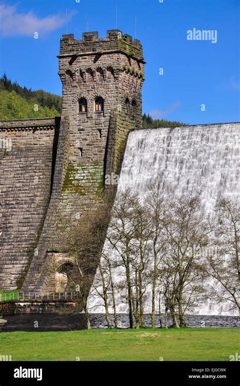 Stone Tower At Derwent Dam With Water Cascading Over The Dam Wall Peak