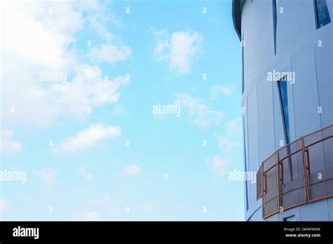 The Concept Of A Building With A Unique Triangular Window With A Bright Sky Background Building