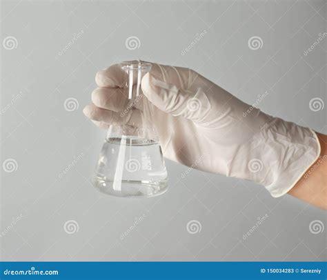 Laboratory Worker Holding Flask With Water On Grey Background Stock Image Image Of Adult