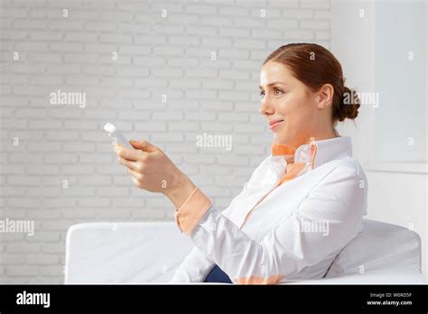 Woman With TV Remote Switching Channels Stock Photo Alamy