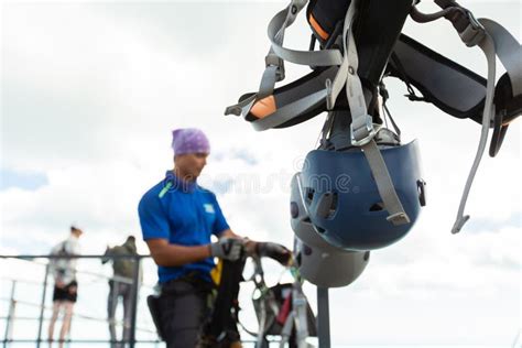 Cheerful Male Instructor Prepares A Rope And Equipment Before Jumping
