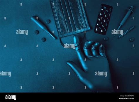 A Switch On The Virus Hand In Glove Mask Tablets Syringe Vials Lie Against A Dark