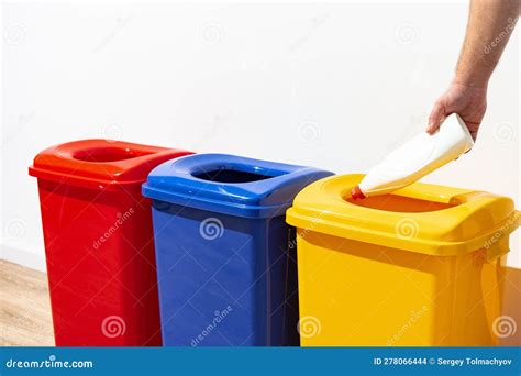 A Man Throws Garbage Into The Trash Can Close Up Photo Stock Photo Image Of Recycle Hand