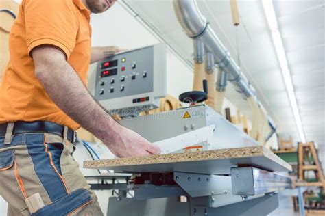 worker pressing buttons on cnc machine in factory stock image image