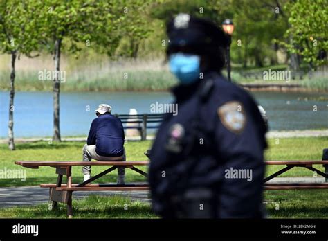 An Nypd School Safety Officer Patrols Baisely Pond Park Enforcing Social Distancing Rules During
