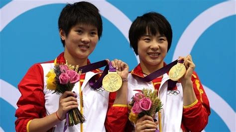 L R Gold Medallists Chen Roulin And Wang Hao Of China Pose On The Podium During The Victory