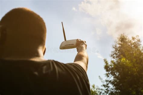 Man Is Looking For Wi Fi Signal In The Nature Guy Is Lost And Holding Router In His Hands