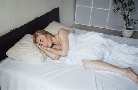 Portrait Of A Beautiful Blonde Woman Sleeping On A Bed In The Bedroom