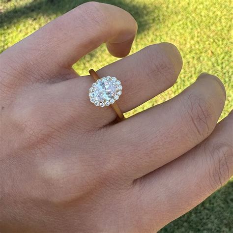 Oval Halo Diamond On A Plain Band Engagement Ring Temple And Grace Usa