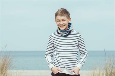 Premium Photo Portrait Of Smiling Girl Standing At Shore