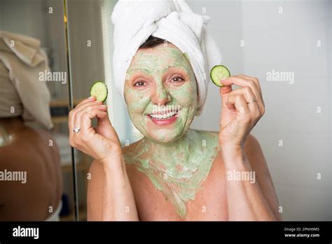 Mature Beautiful Woman Applying Green Homemade Diy Facial Mask On Skin
