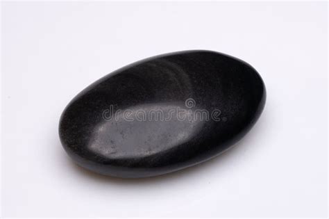 Smooth Polished Black River Stone Isolated On A Plain White Background Showcasing Its Organic