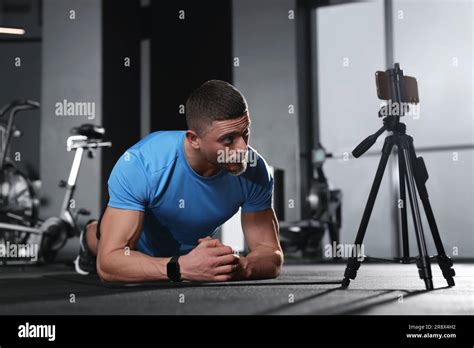 Trainer Streaming Online Workout With Phone At Gym Stock Photo Alamy