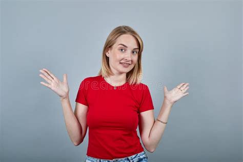 Attractive Caucasian Young Woman Spreading Hands And Looking So Funny Pretty Stock Image