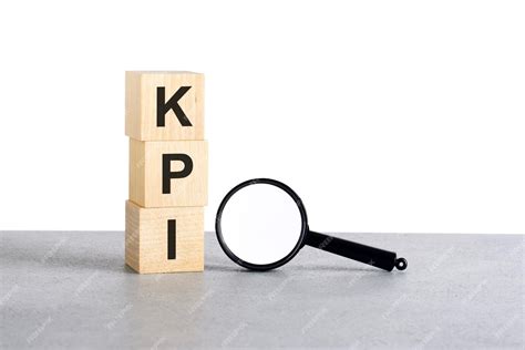 Premium Photo Kpi Key Performance Indicators Text On Wooden Cube Blocks And Magnifying Glass