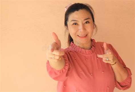 Portrait Of Pretty Woman Pointing Finger Left And Right Smiling As Inviting Look At Camera