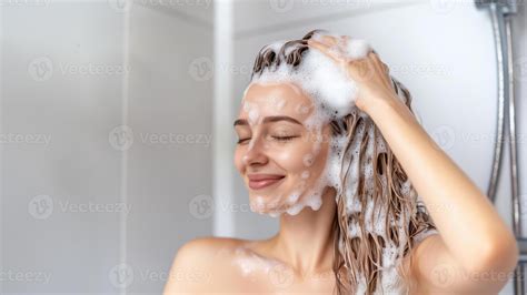Blonde Young Woman Washing Her Hair With Shampoo In The Shower 68352764