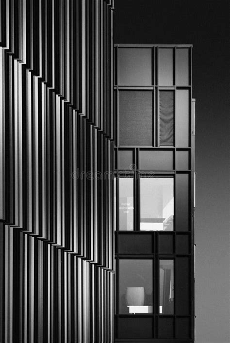 Grayscale Of A Structure Featuring A Series Of Windows With A Backdrop