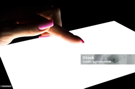 검은 배경에 고립 된 여성의 손에 태블릿 컴퓨터 모형 밤에 빈 흰색 화면 태블릿 노트북 모형 텍스트의 빈 공간입니다 공간을 복사합니다 격리 된 화면 클리핑 경로 가정용