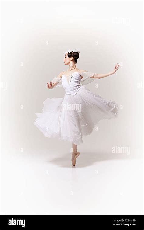 Charming Young Woman Ballerina In White As Snow Dress Poses