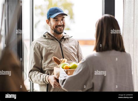 Food Delivery Man Giving Order To Female Customer Stock Photo Alamy
