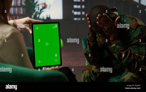 Black Army Soldier Crying At Therapy Session Next To Chroma Key Screen Seeking Professional