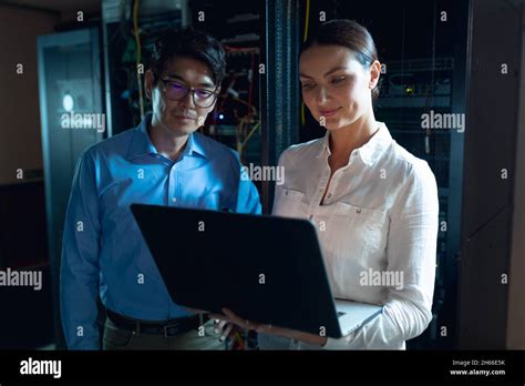 Diverse Male And Female Engineers Using Laptop In Computer Server Room Stock Photo Alamy