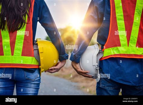 Male And Female Engineer Holding Hardhat Safety Stock Photo Alamy